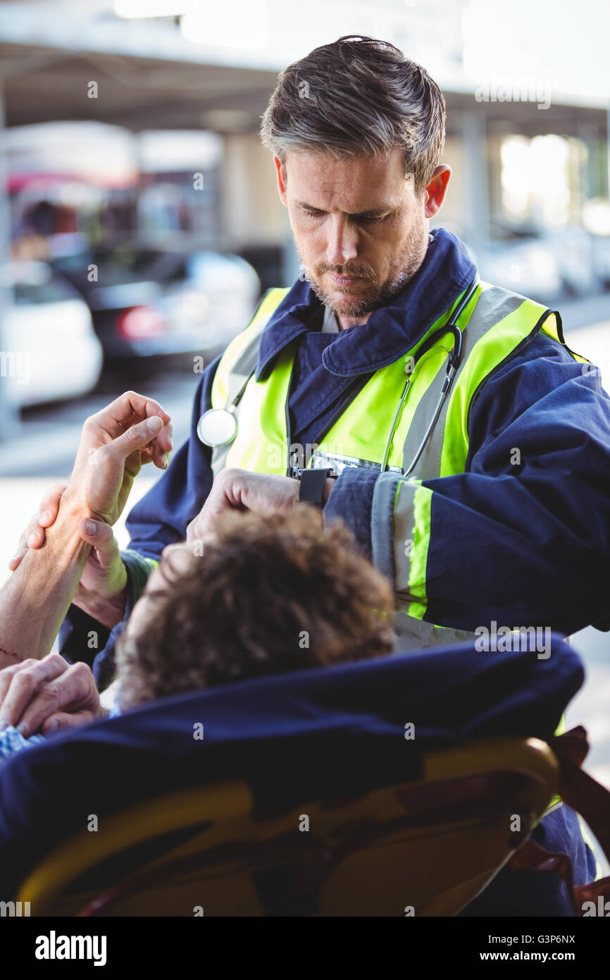 Ambulance man taking care of injured man Stock Photo - Alamy