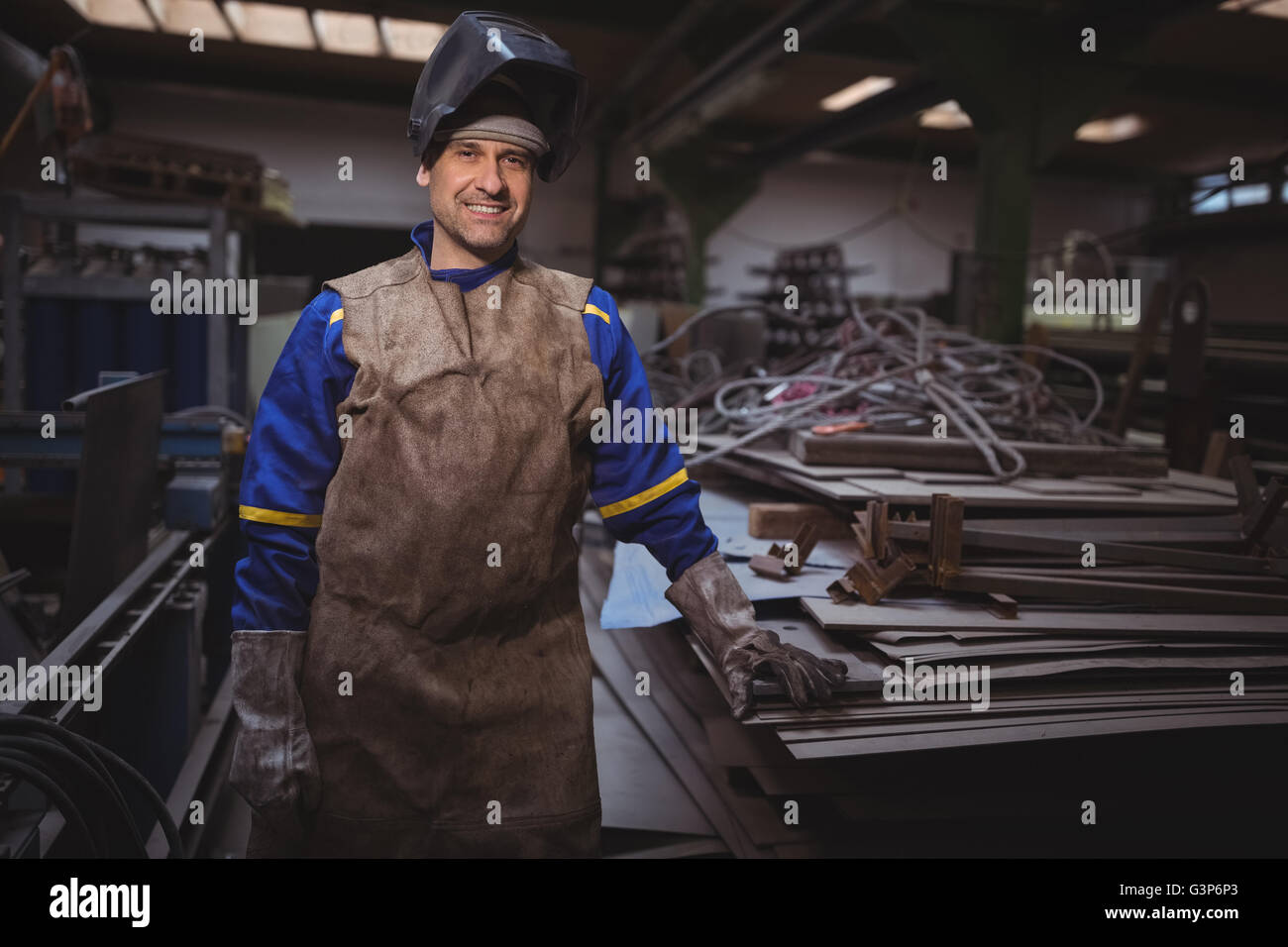Portrait of smiling welder in workshop Stock Photo - Alamy