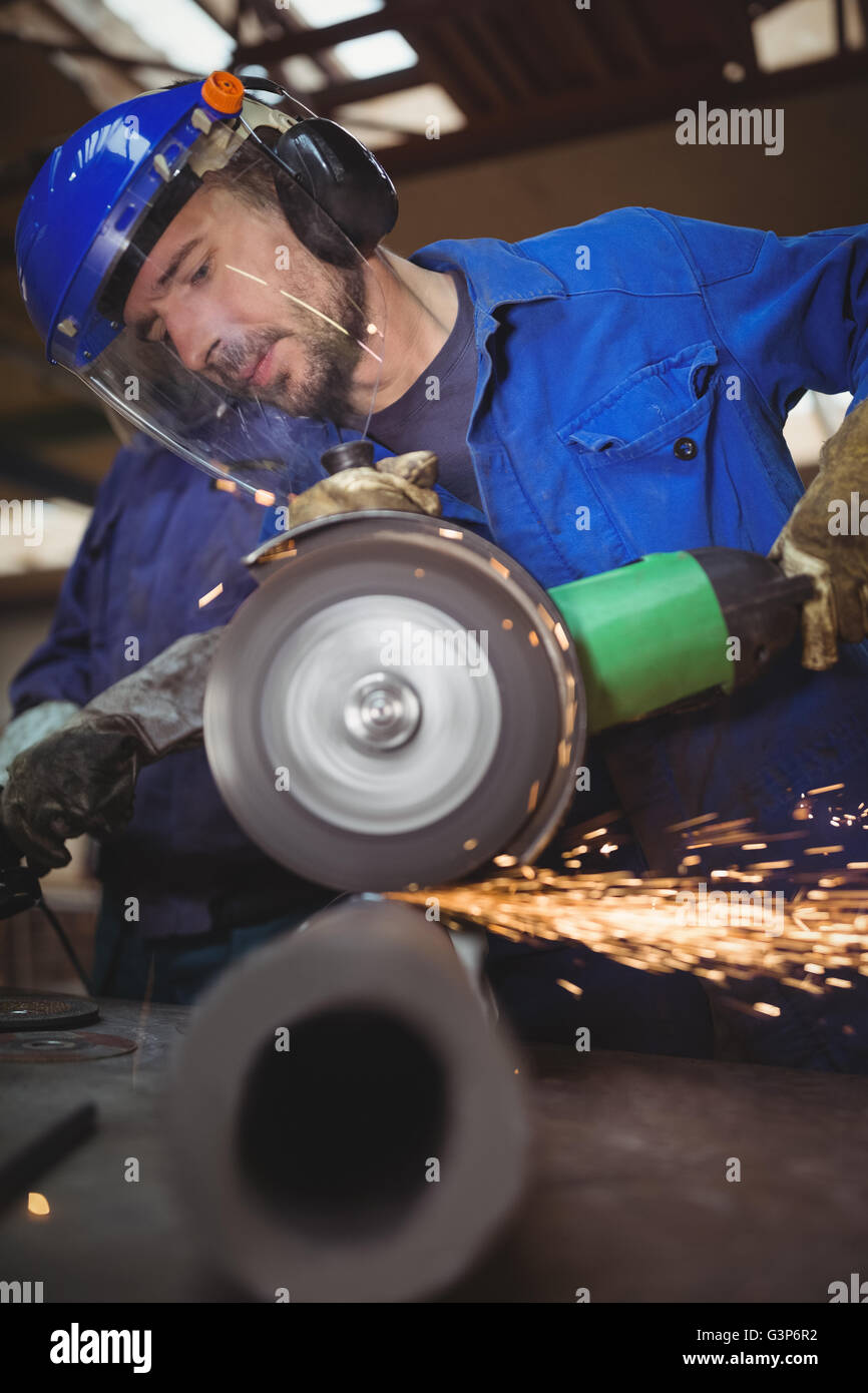 Man cutting metal with circular saw Stock Photo - Alamy