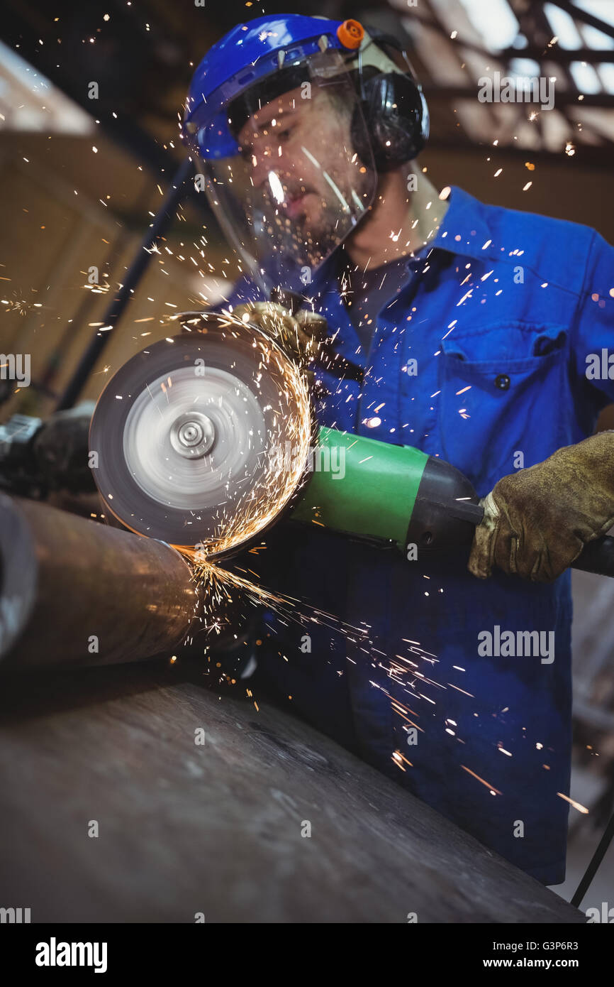 Man cutting metal with circular saw Stock Photo - Alamy