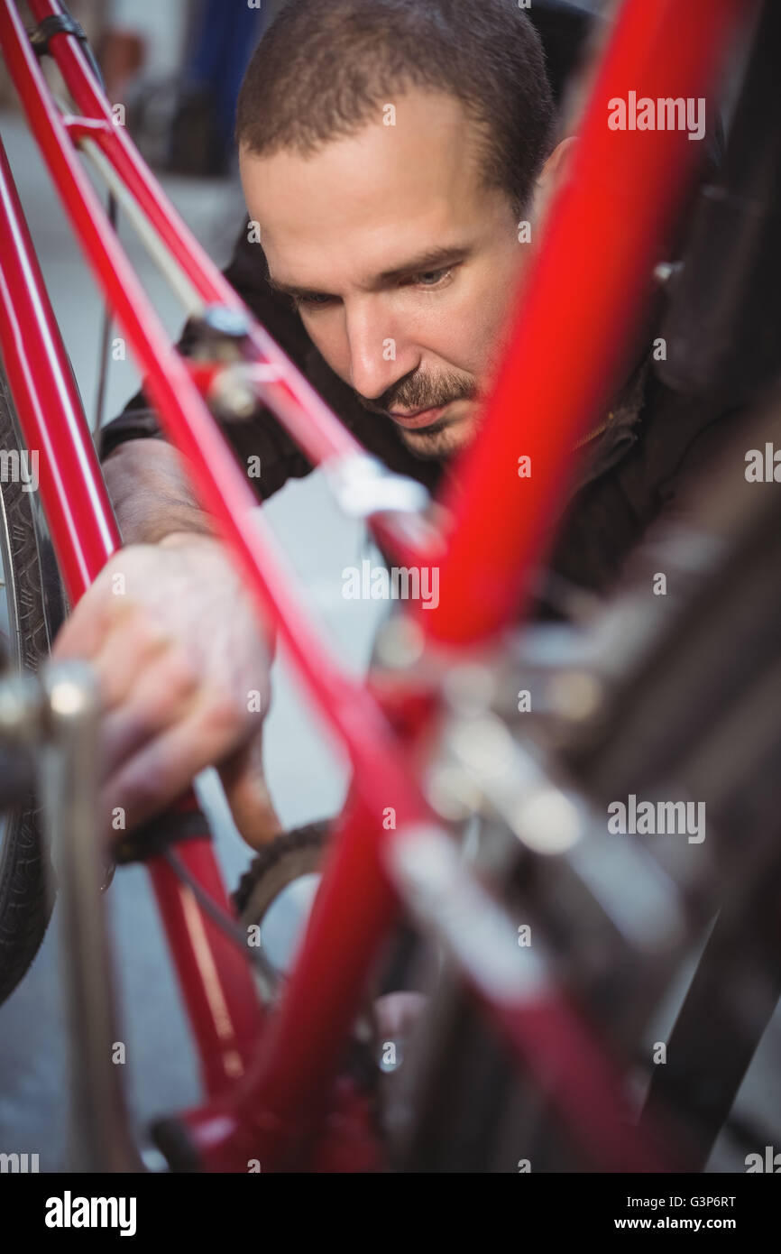 Mechanic repairing a bicycle Stock Photo - Alamy