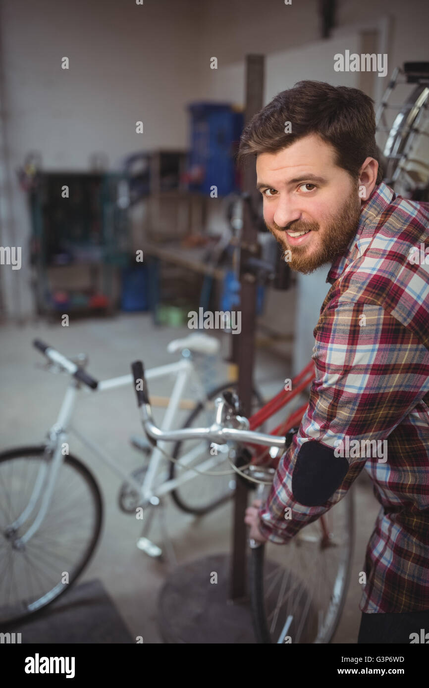 Portrait of mechanic repairing a bicycle Stock Photo - Alamy