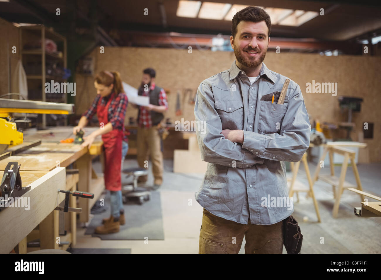 Portrait of carpenter standing with arms crossed in workshop Stock ...