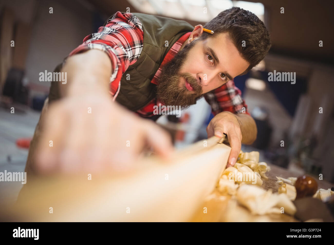 Carpenter measuring wooden plank Stock Photo - Alamy