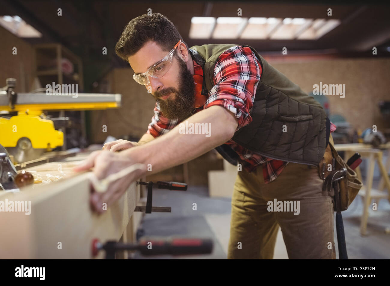 Carpenter measuring wooden plank Stock Photo - Alamy