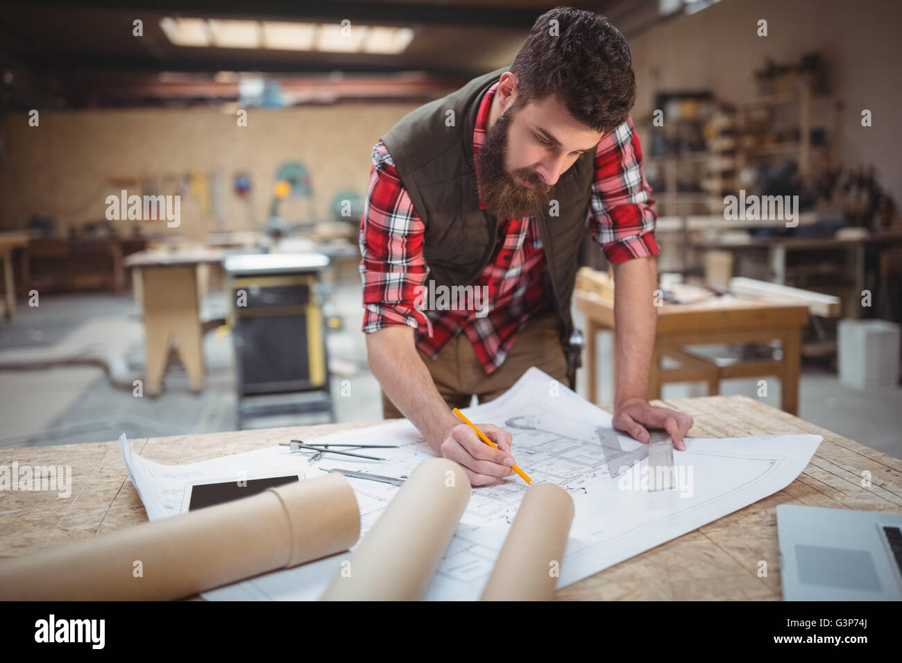 Carpenter working on a blueprint Stock Photo - Alamy