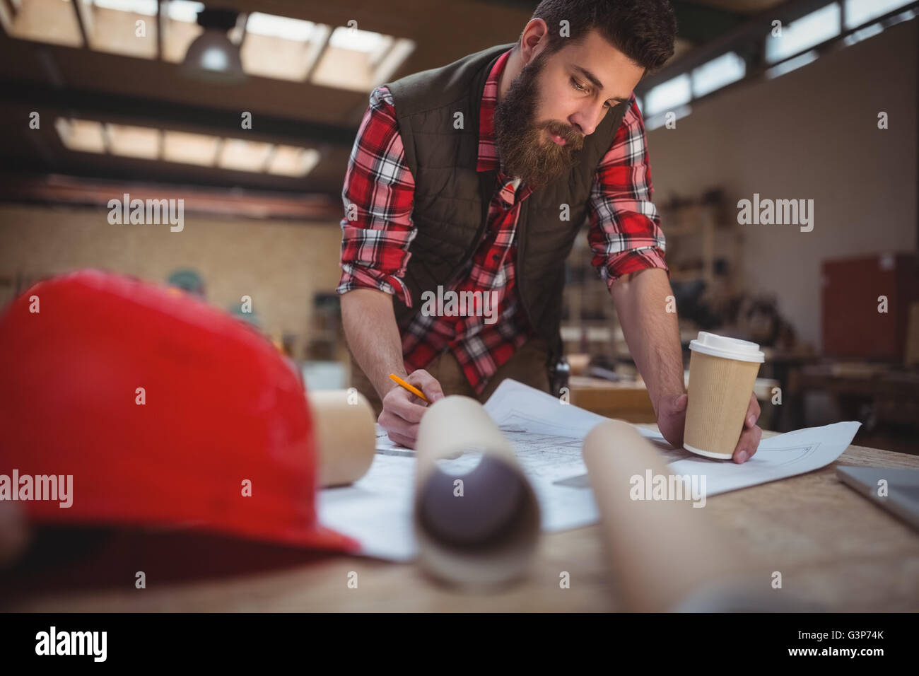 Carpenter working on a blueprint Stock Photo - Alamy
