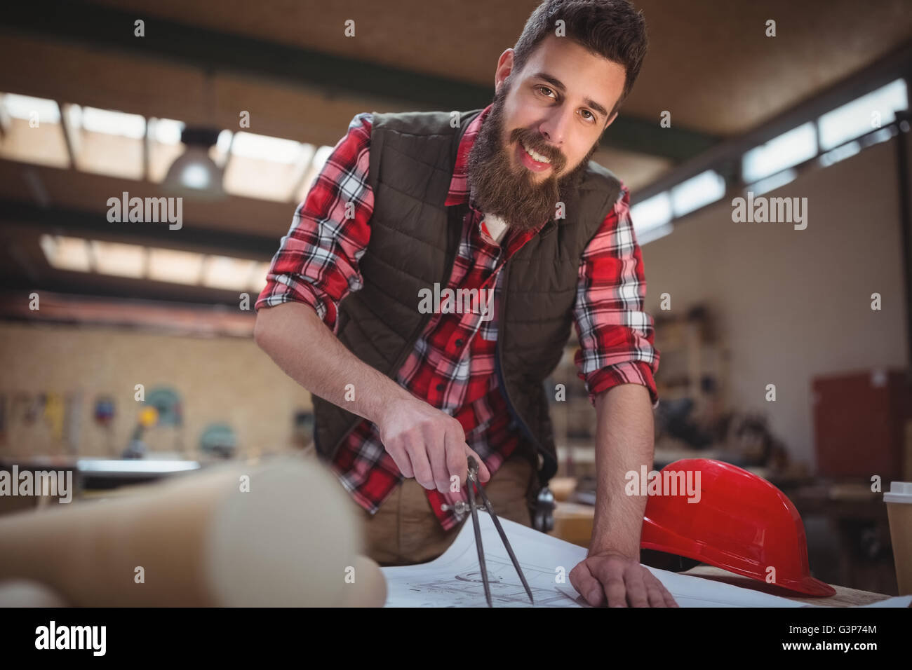 Carpenter working on a blueprint Stock Photo - Alamy