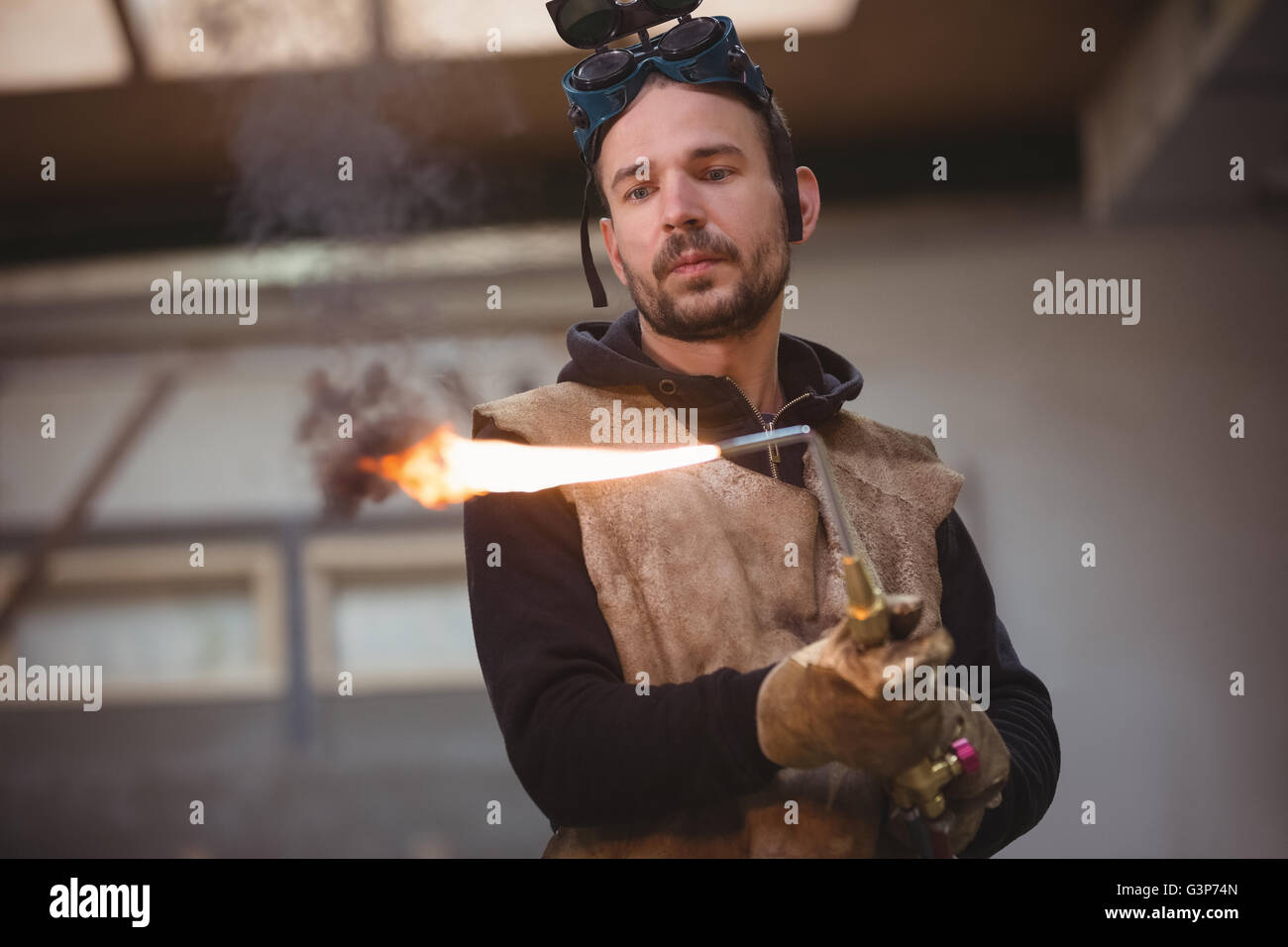Welder holding a welding torch Stock Photo - Alamy