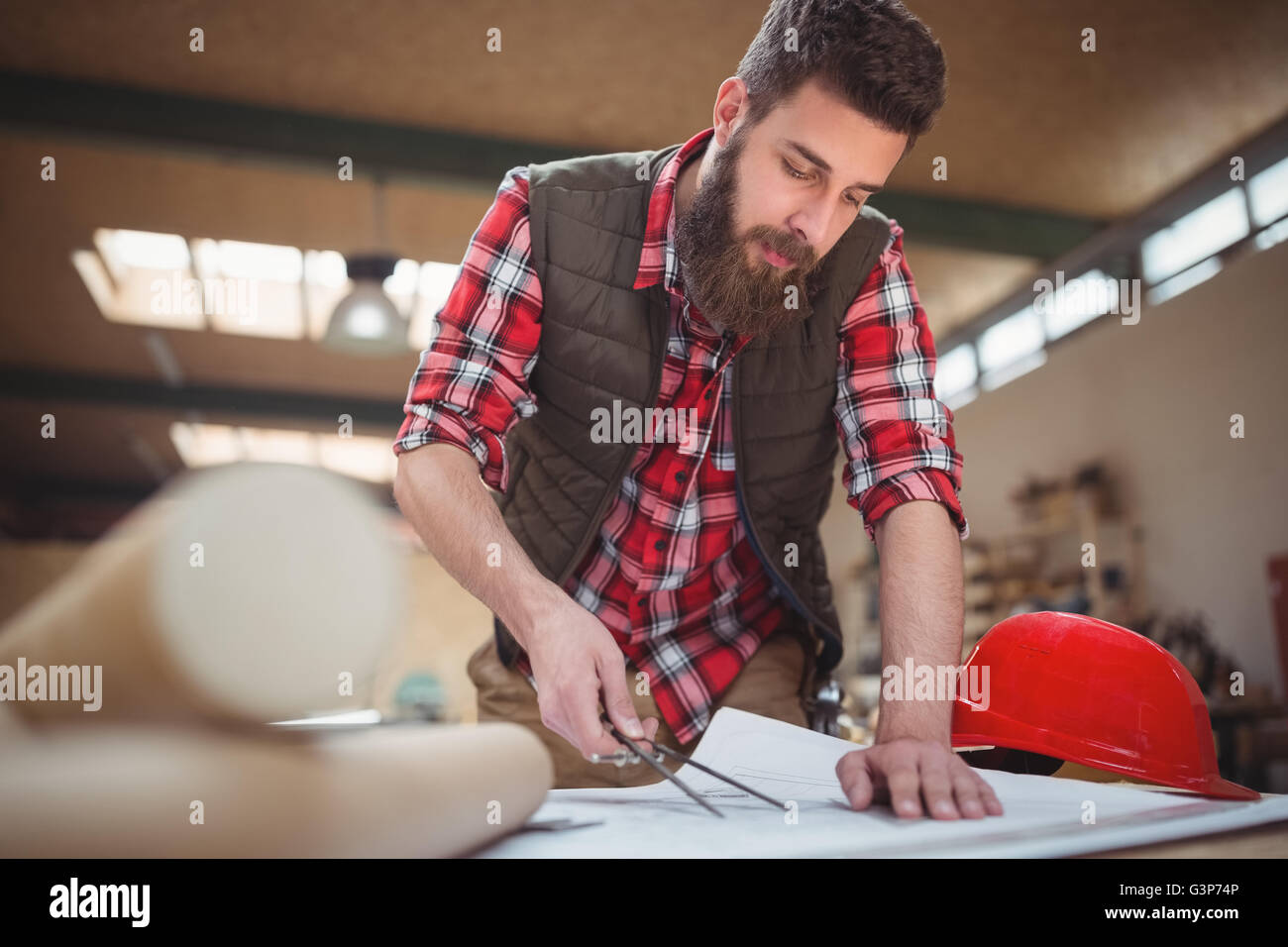Carpenter working on a blueprint Stock Photo - Alamy