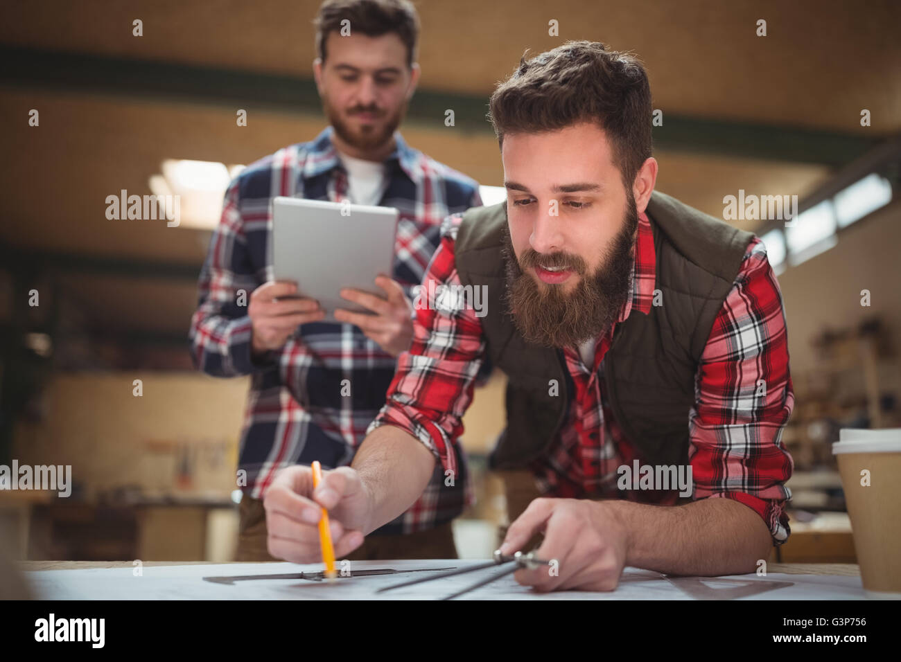 Carpenter working on a blueprint Stock Photo - Alamy