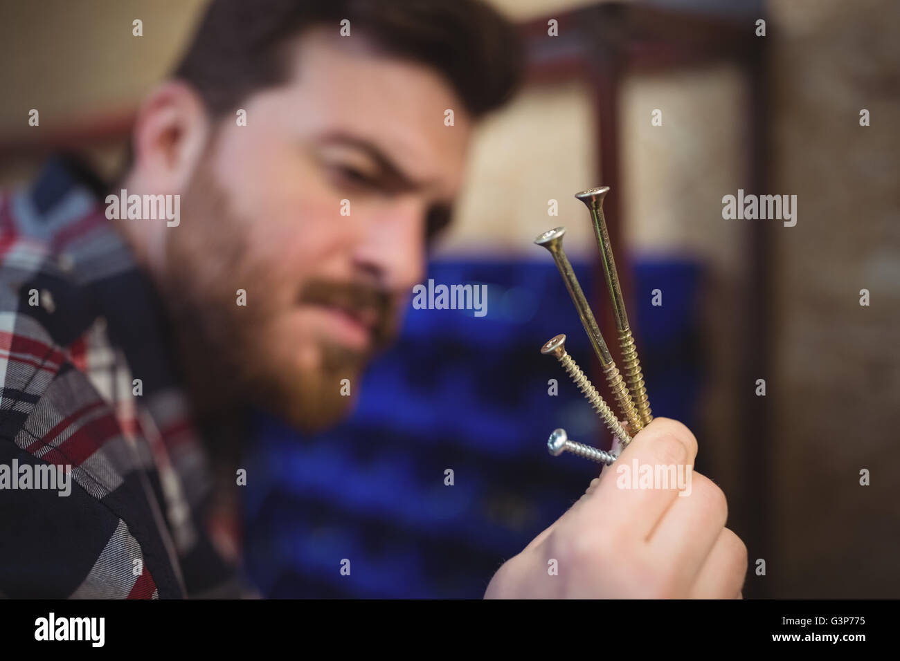 Carpenter holding nails Stock Photo - Alamy