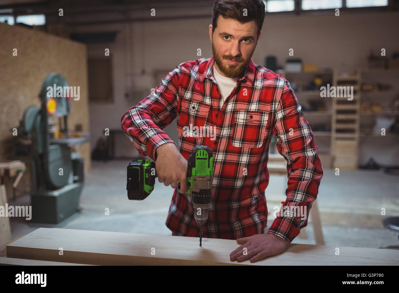 Young man using drill machine hi-res stock photography and images - Alamy