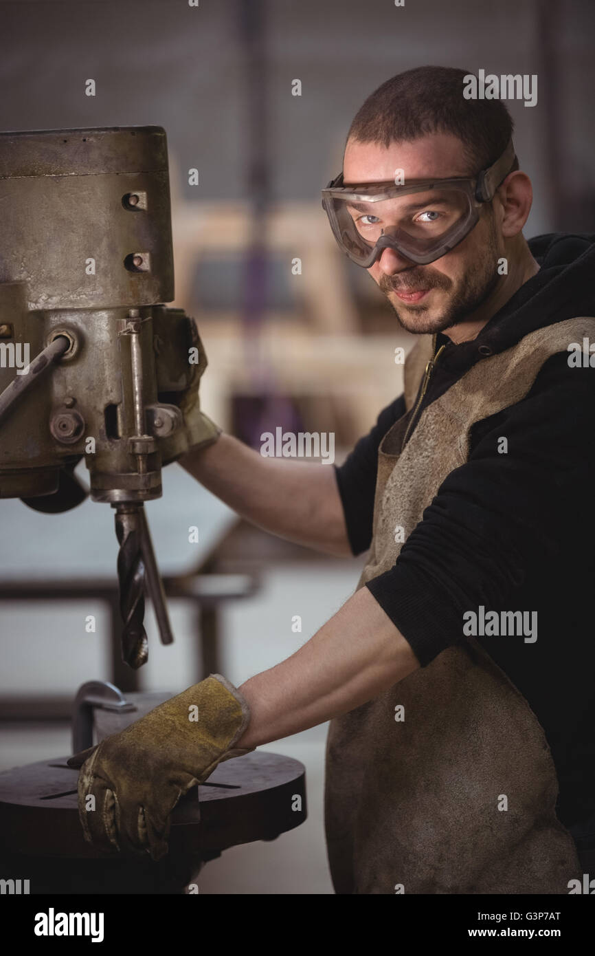 Tradesman working with machine Stock Photo - Alamy