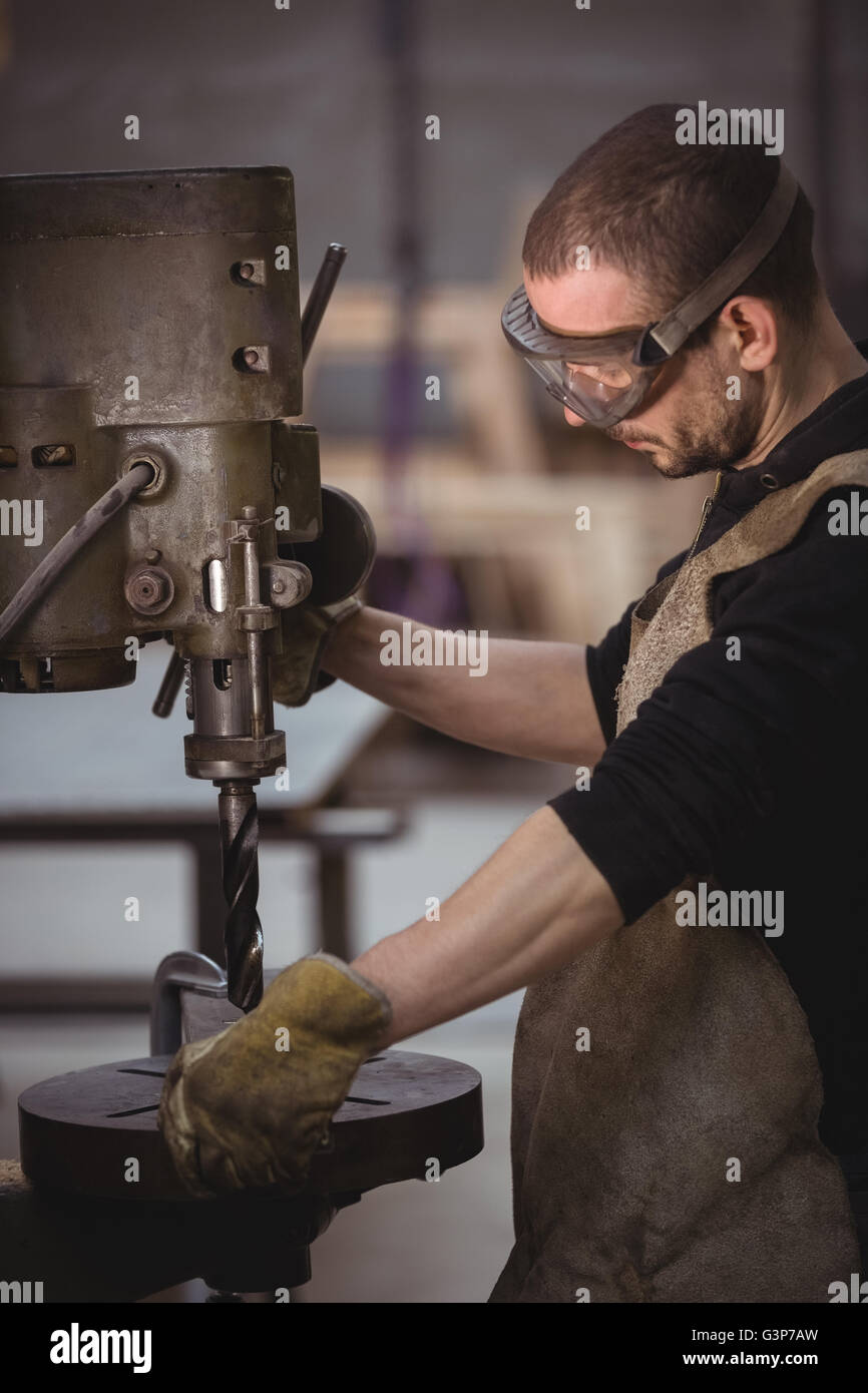 Tradesman working with machine Stock Photo - Alamy