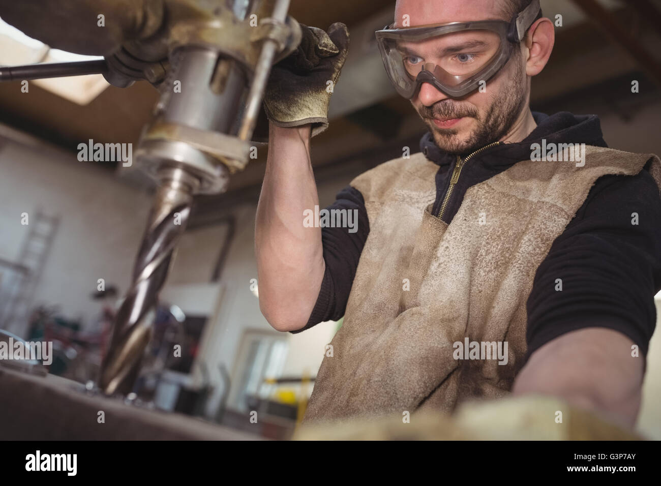 Tradesman working with machine Stock Photo - Alamy