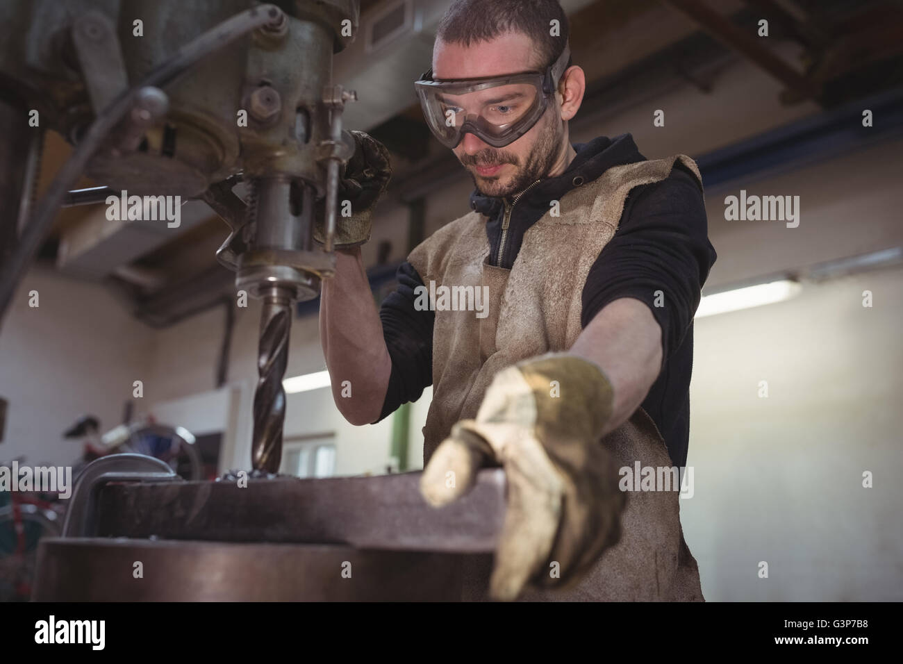 Tradesman working with machine Stock Photo - Alamy