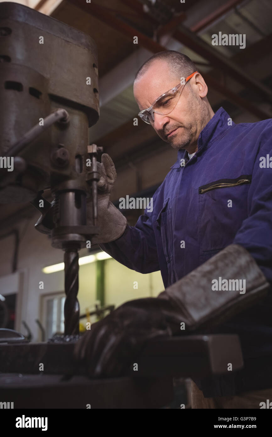 Tradesman working with machine Stock Photo - Alamy