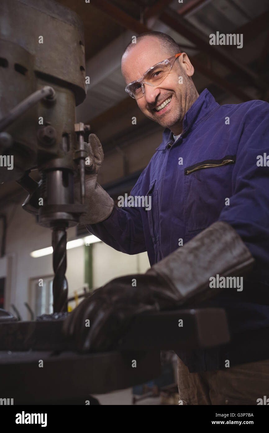 Tradesman working with machine Stock Photo - Alamy