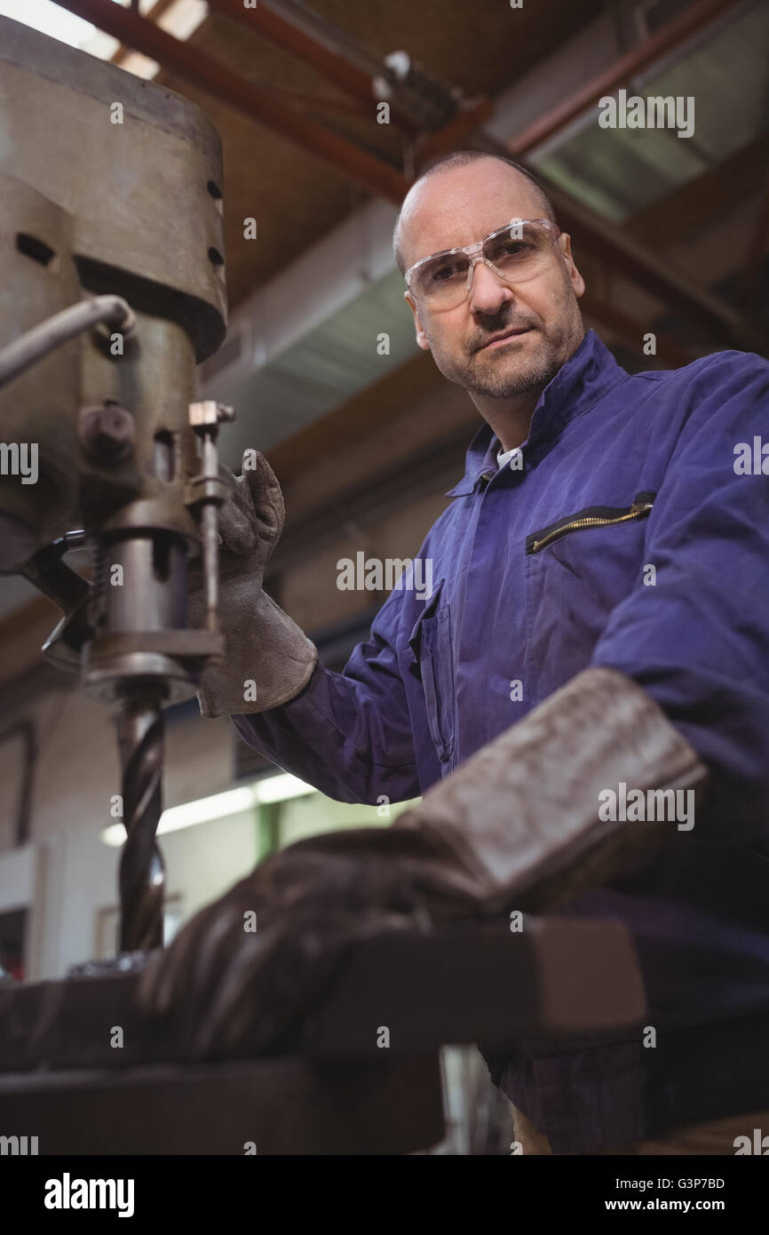 Tradesman working with machine Stock Photo - Alamy