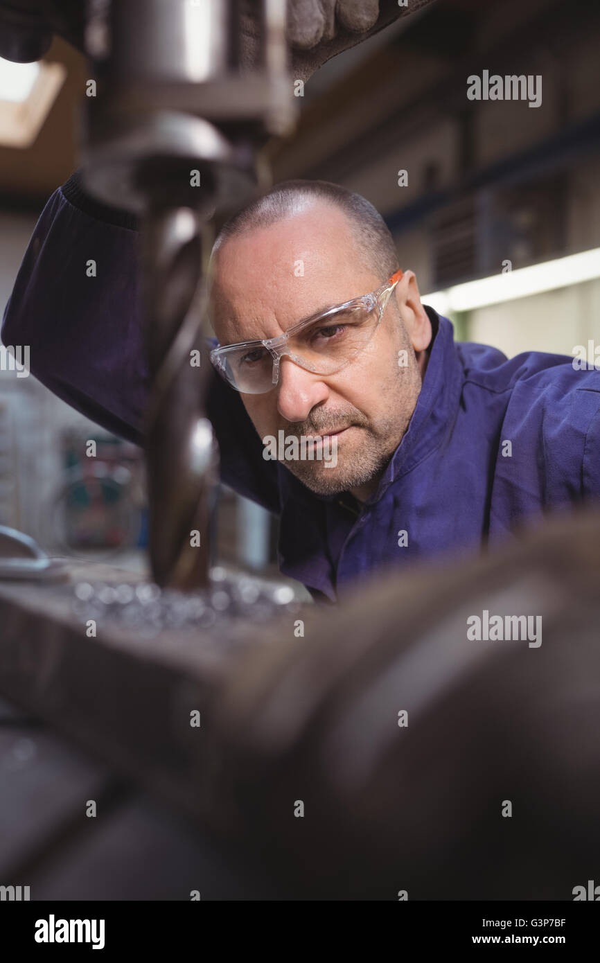Tradesman working with machine Stock Photo - Alamy