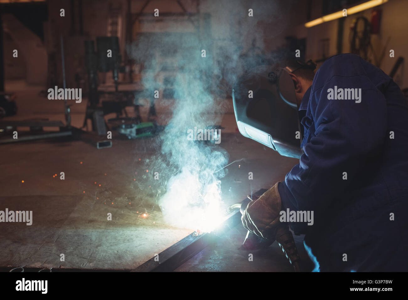 Welder working with machine Stock Photo - Alamy