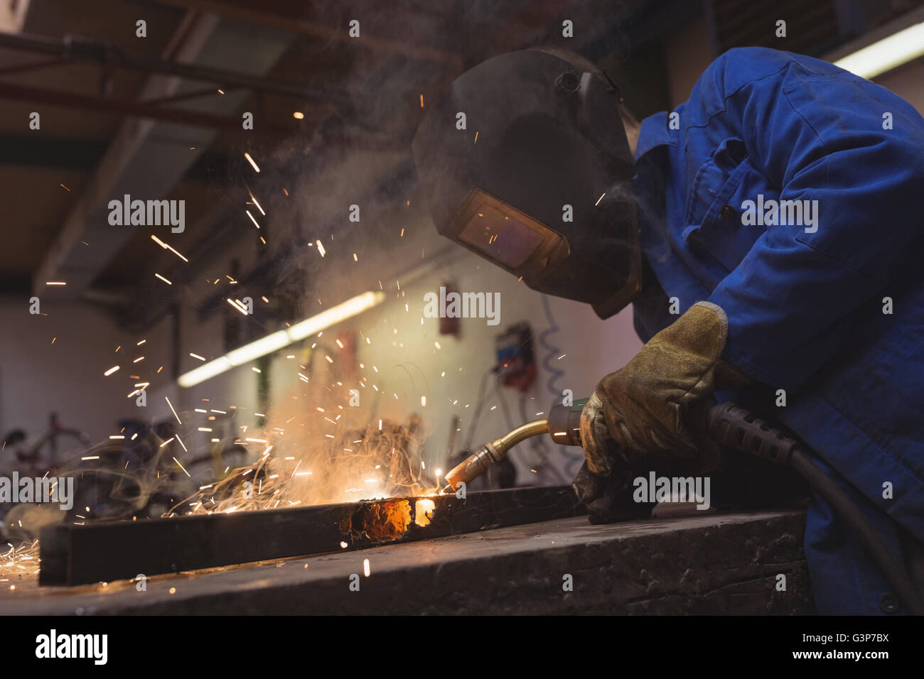 Welder working with machine Stock Photo - Alamy