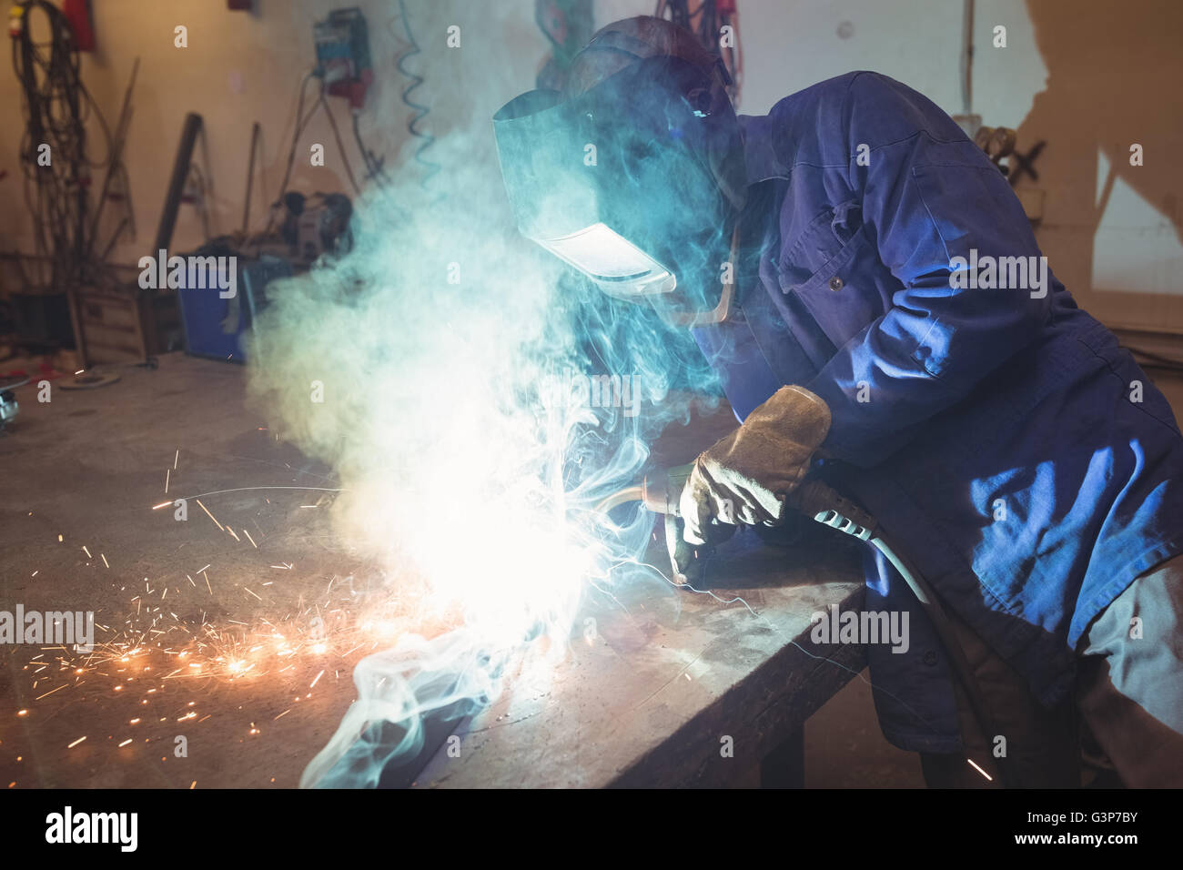 Welder working with machine Stock Photo - Alamy