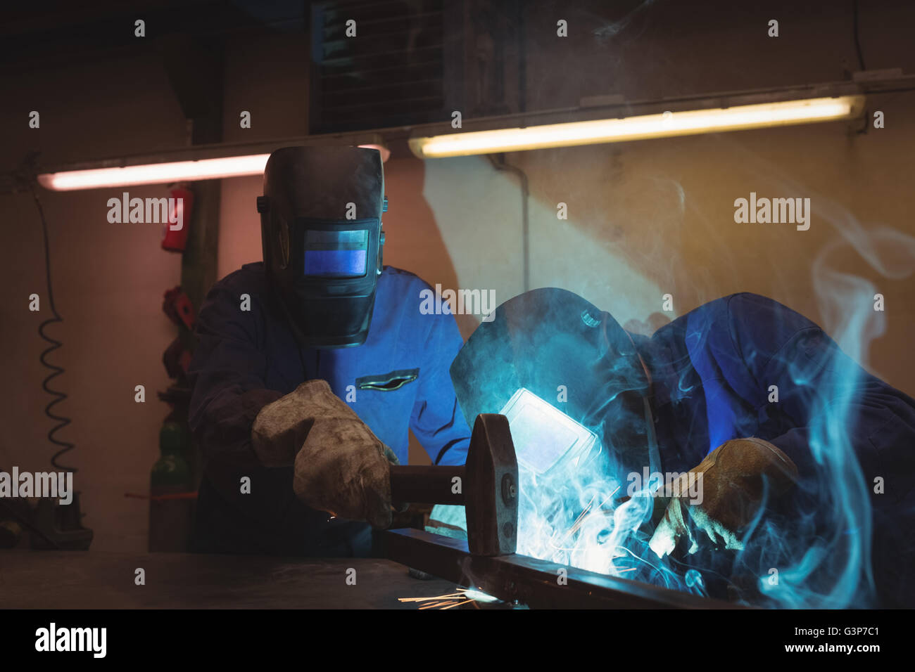 Welder working with machine Stock Photo - Alamy