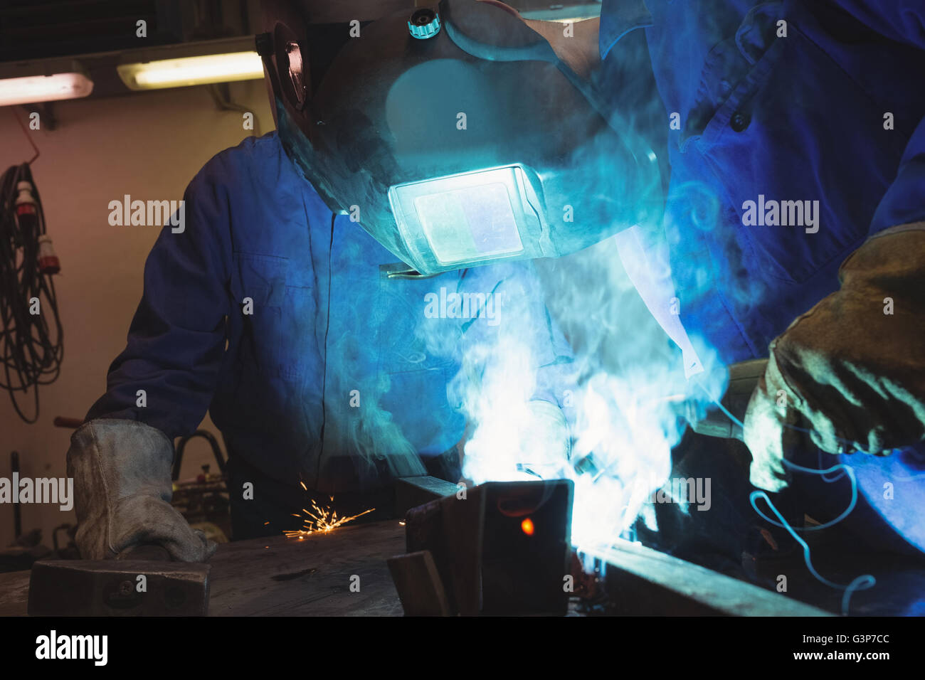 Welder working with machine Stock Photo - Alamy