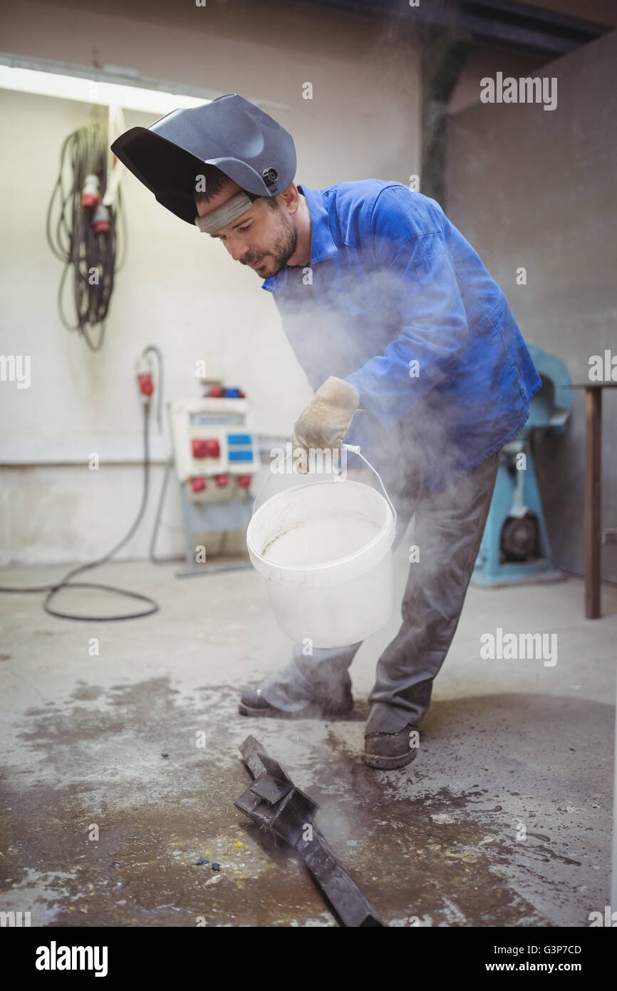 Worker holding a bucket Stock Photo - Alamy