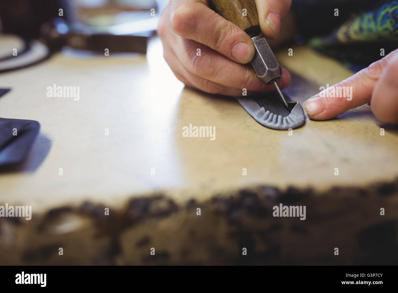 Cobbler working on a shoe with a work tool Stock Photo - Alamy