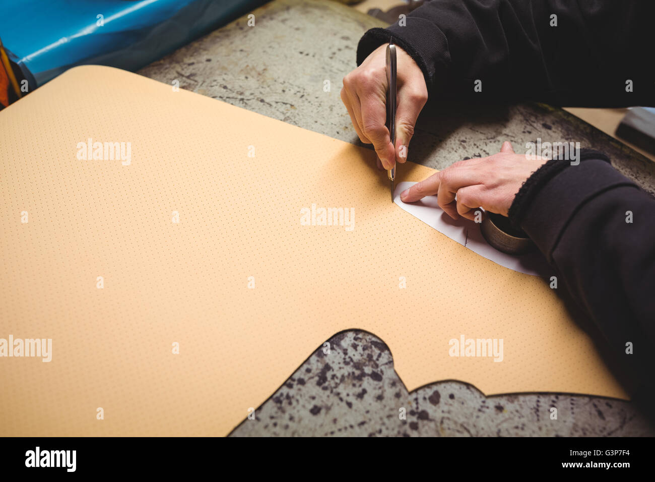 Cobbler cutting a design from material Stock Photo - Alamy