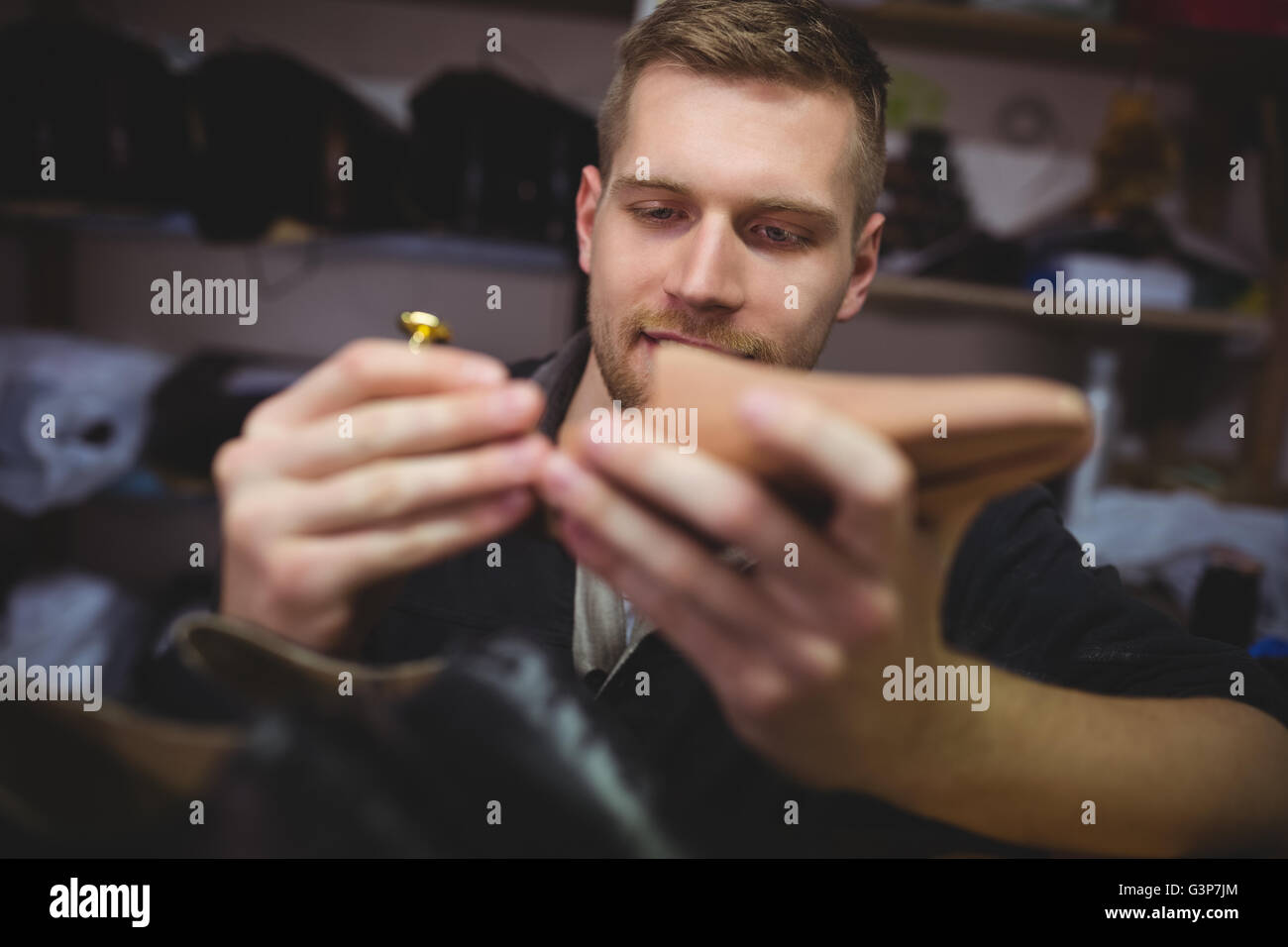 Cobbler holding a shoe tree Stock Photo - Alamy