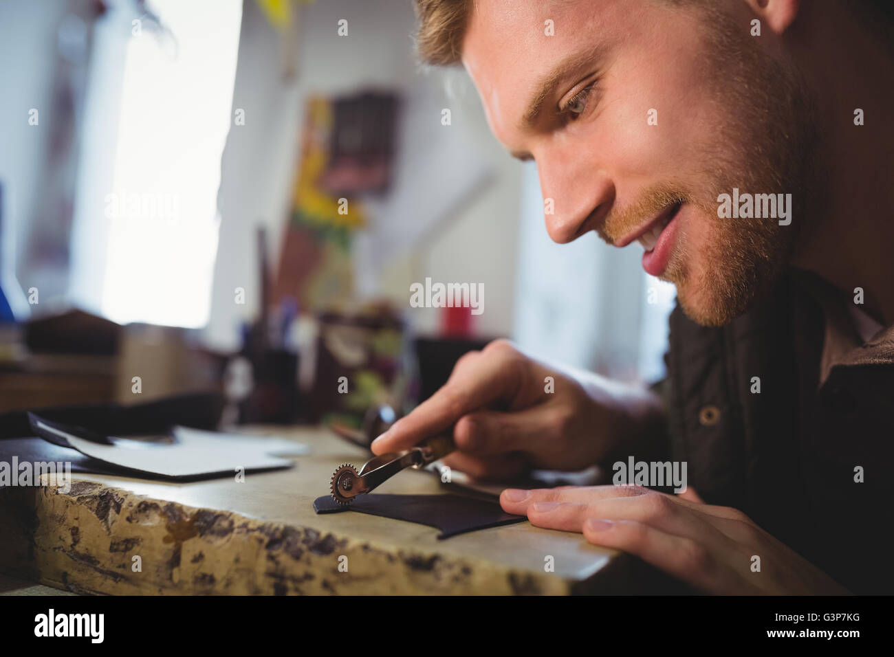 Cobbler using a tool on a material Stock Photo - Alamy