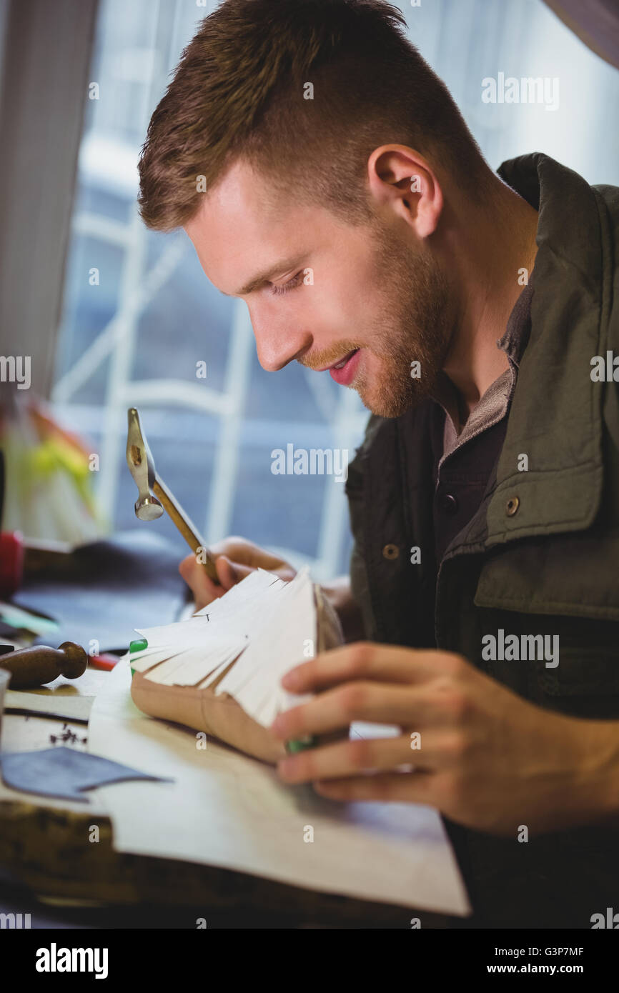 Cobbler hammering nail on shoemaker Stock Photo - Alamy