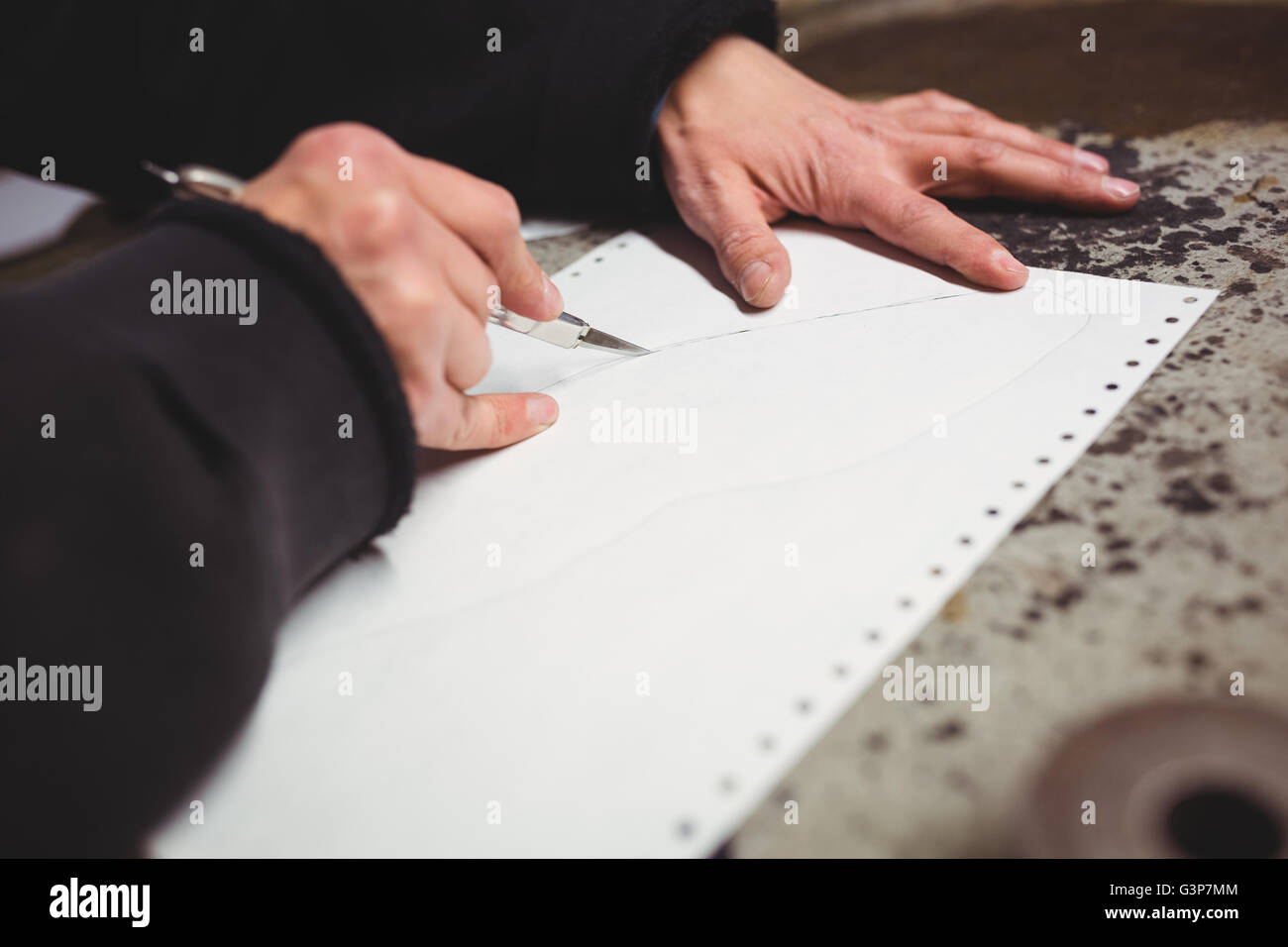 Cobbler cutting a paper sheet Stock Photo - Alamy