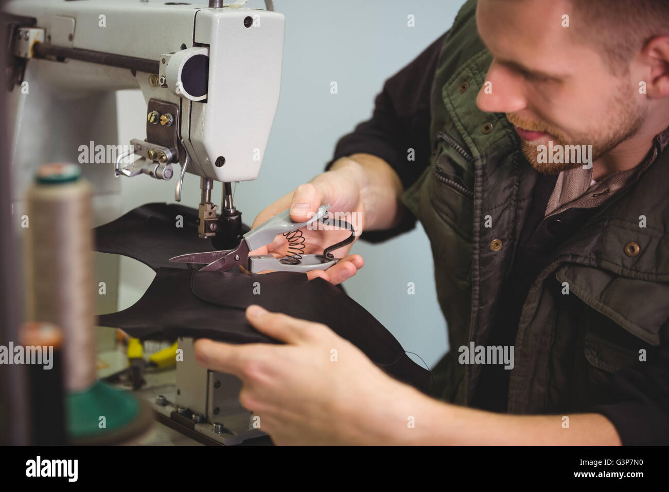 Cobbler using sewing machine Stock Photo - Alamy