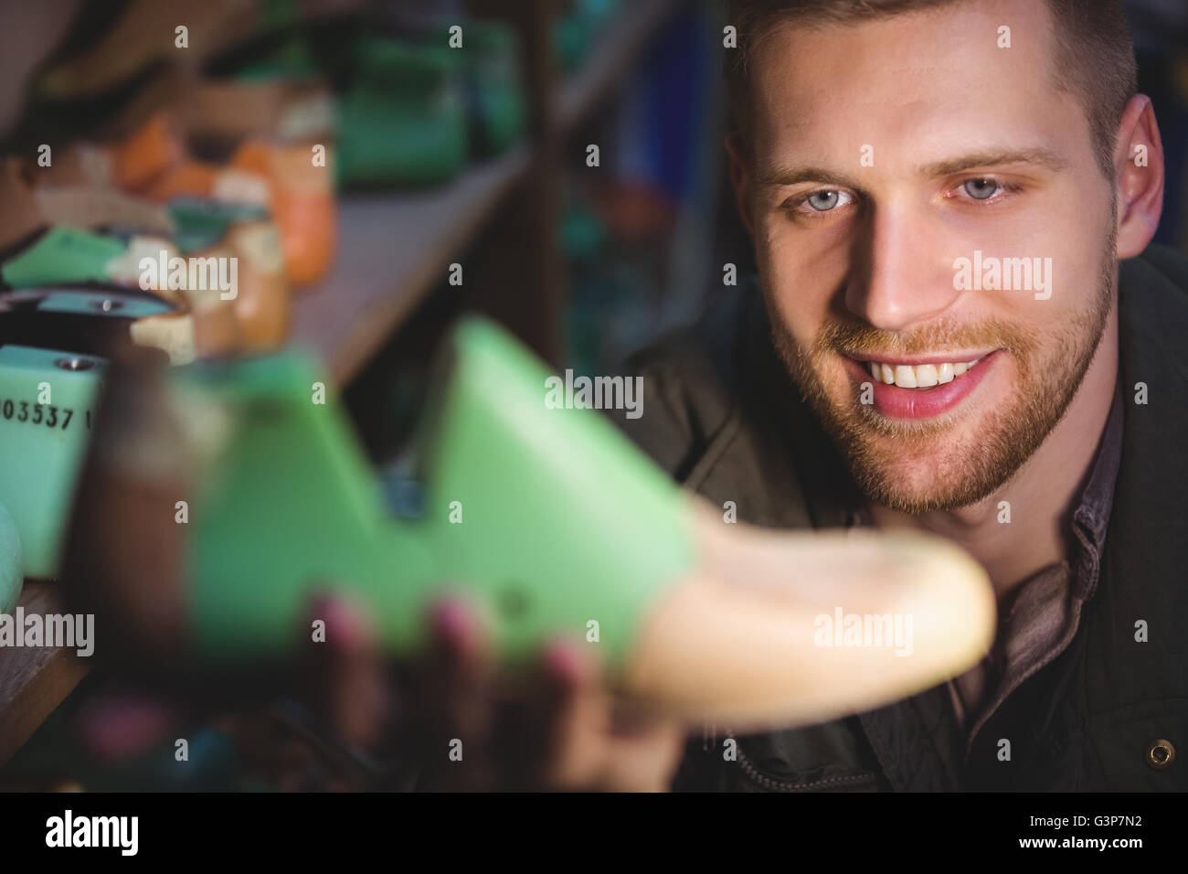 Cobbler holding a shoemaker Stock Photo - Alamy