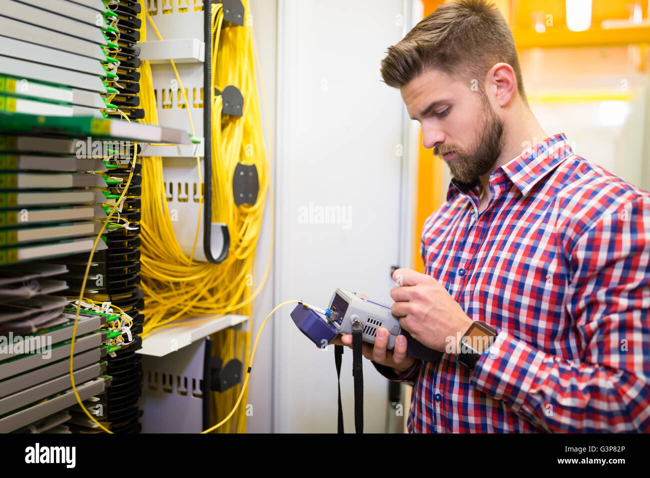 Technician holding digital cable analyzer Stock Photo - Alamy