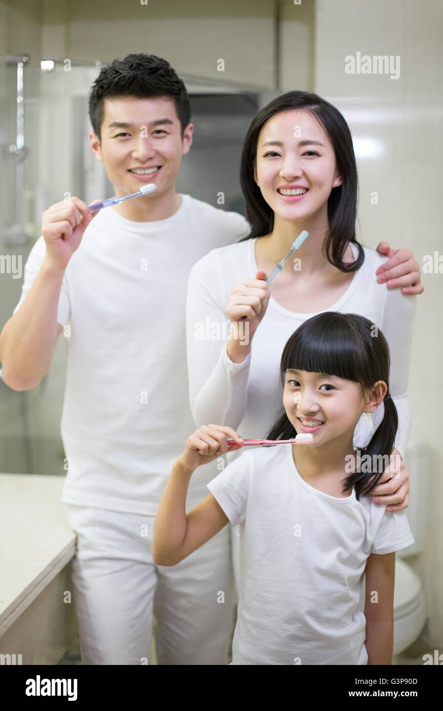 Happy young family brushing teeth Stock Photo - Alamy