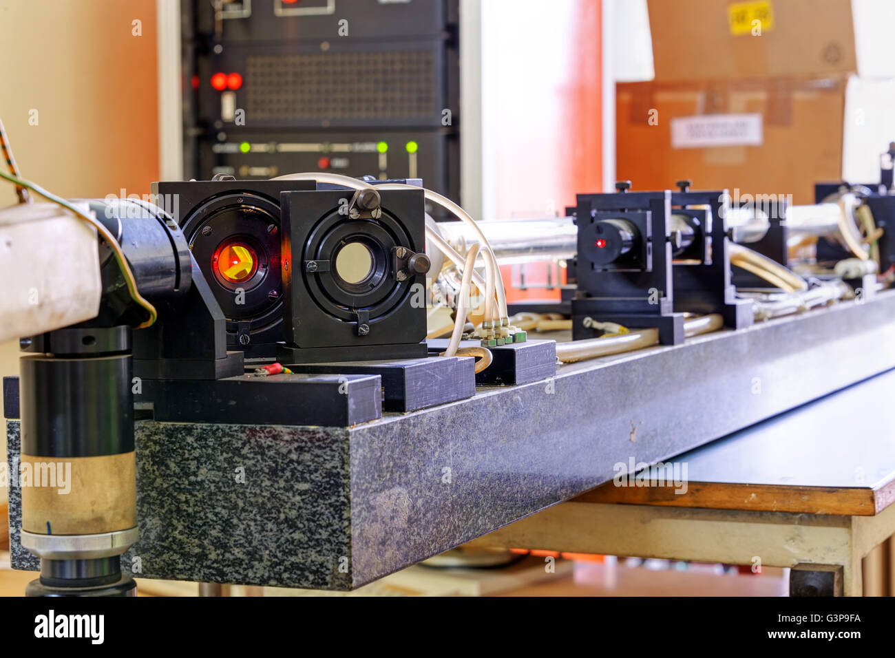 Red laser on optical table in physics laboratory Stock Photo - Alamy
