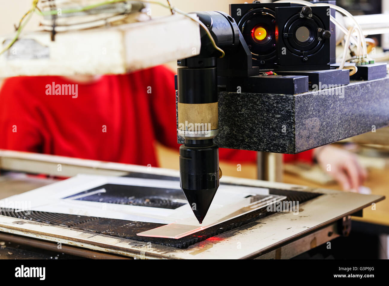 Red laser on cutting machine in physics laboratory Stock Photo - Alamy
