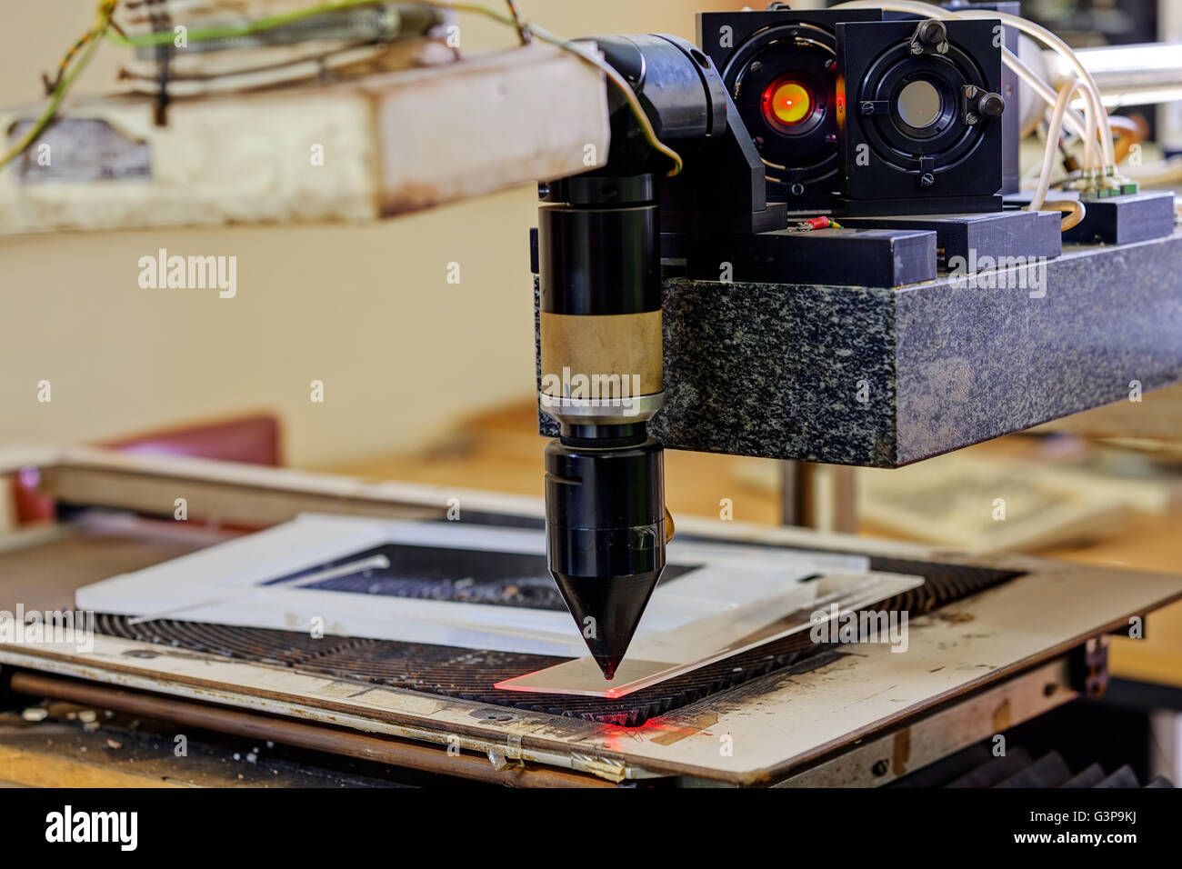 Red laser on cutting machine in physics laboratory Stock Photo - Alamy