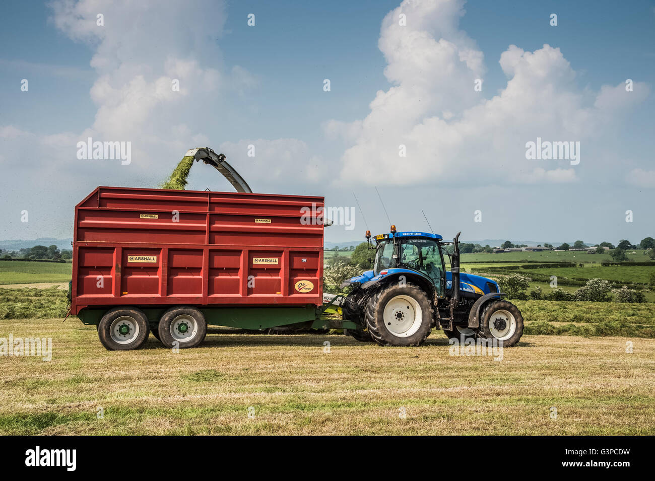 Farmers at work cutting grass and hay-making Stock Photo - Alamy