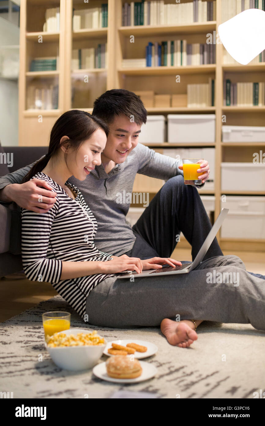 Bright couple using laptop on hi-res stock photography and images - Alamy