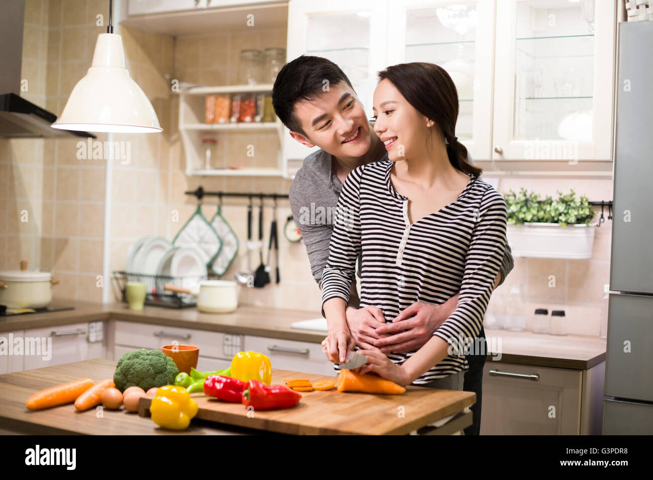 Young couple cooking in kitchen Stock Photo - Alamy
