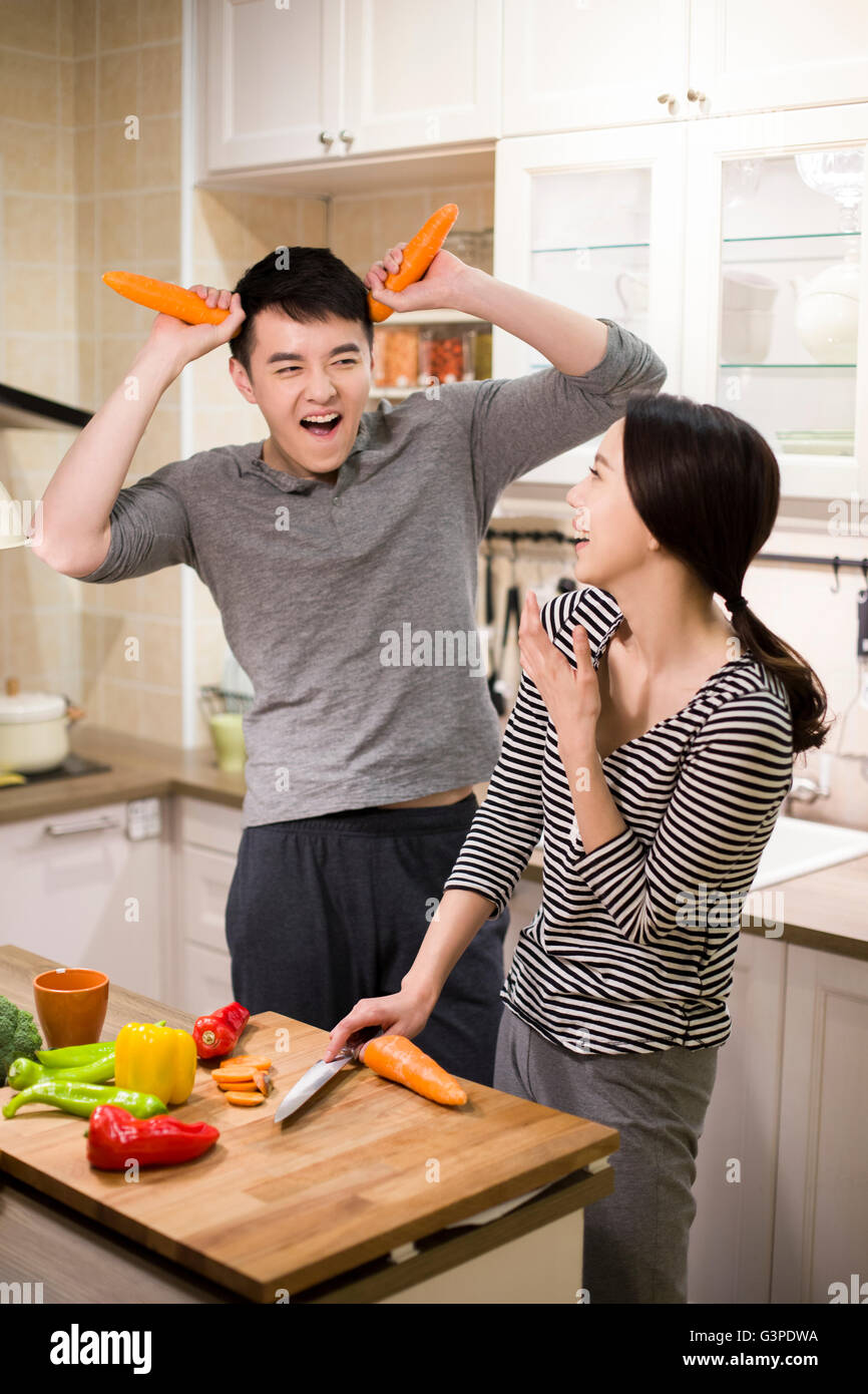 Young couple cooking in kitchen Stock Photo - Alamy