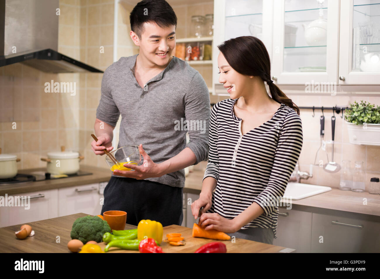 Young couple cooking in kitchen Stock Photo - Alamy