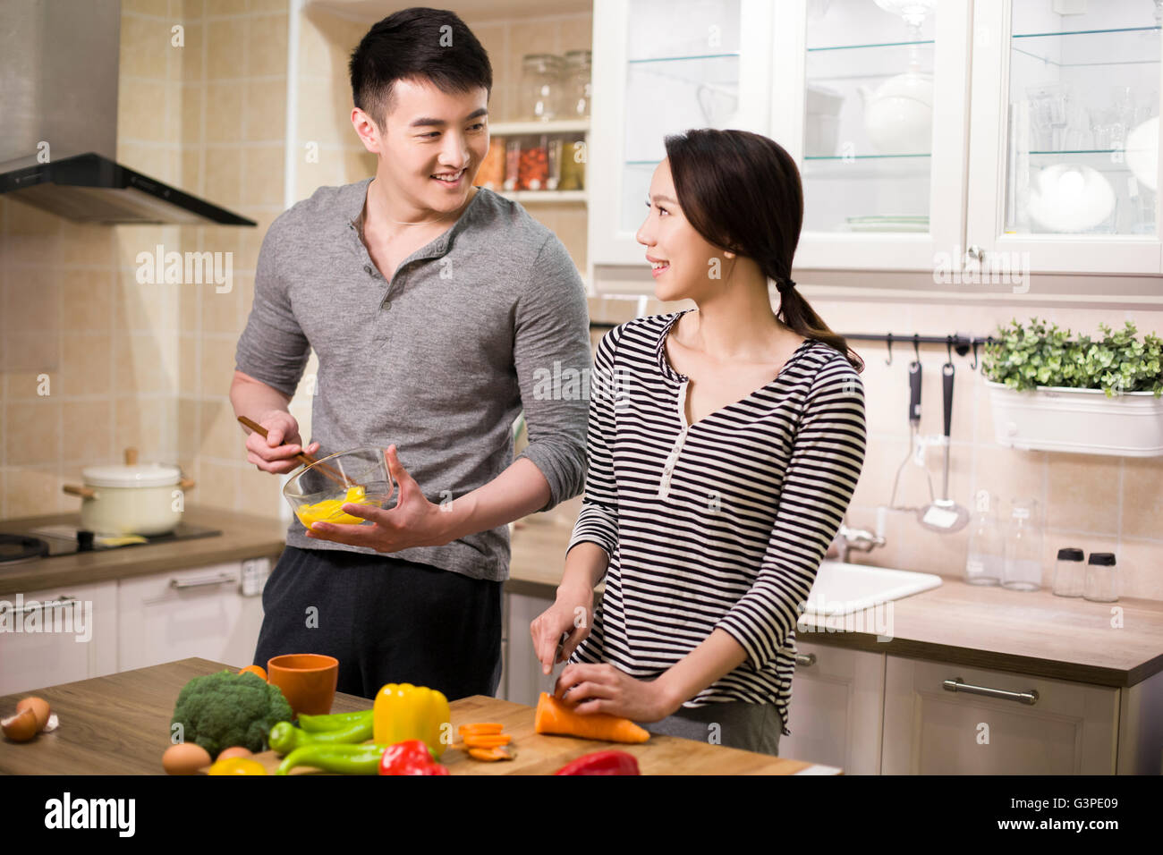 Young couple cooking in kitchen Stock Photo - Alamy